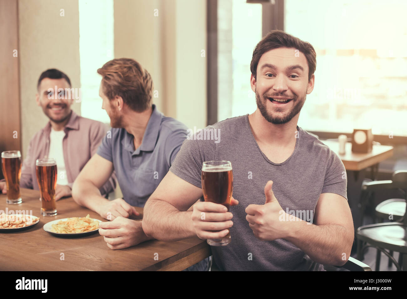 Friends having fun in pub Stock Photo - Alamy