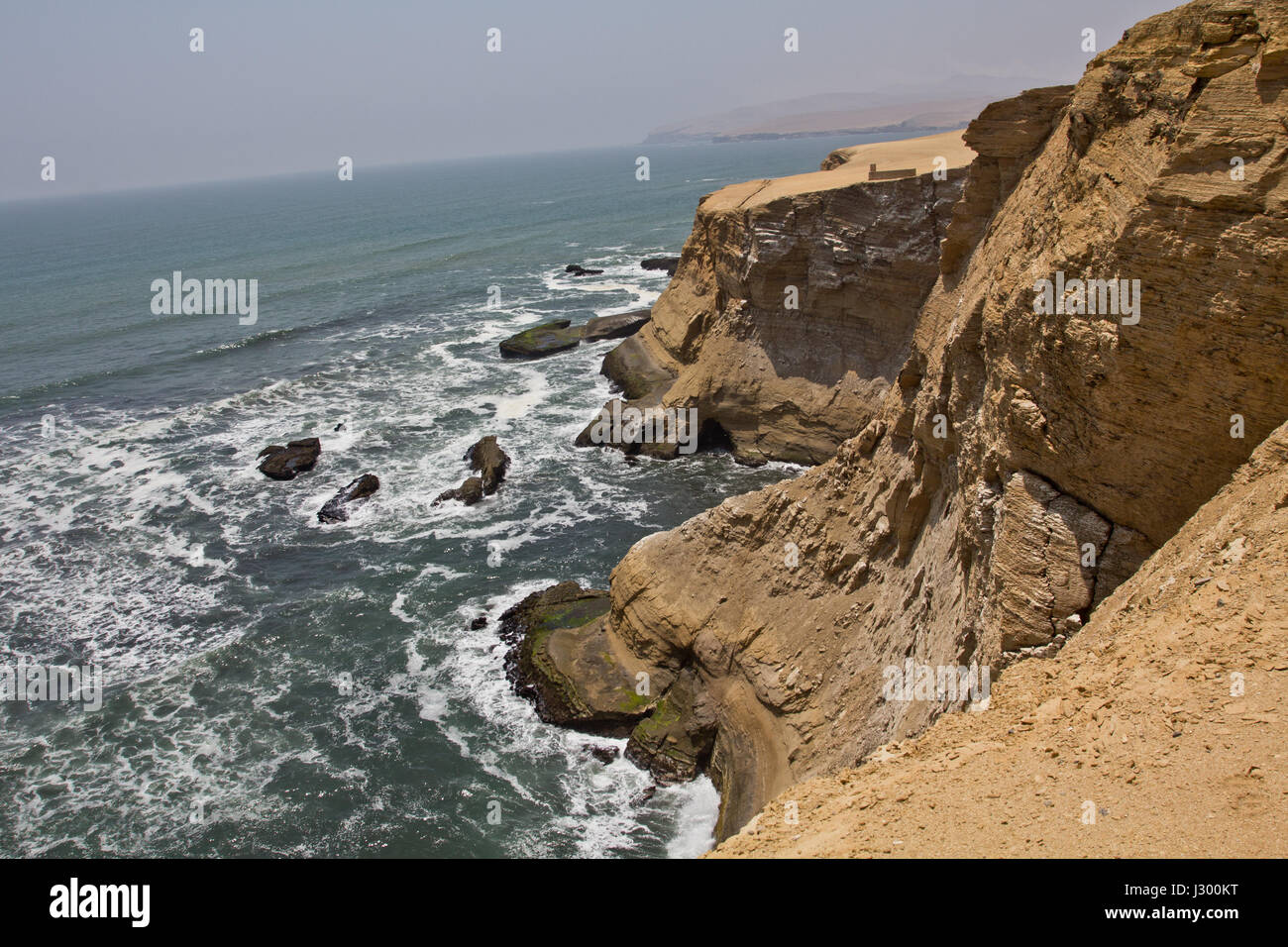 Rocky cliff and ocean with surf. Perfect place to see tropical desert ...