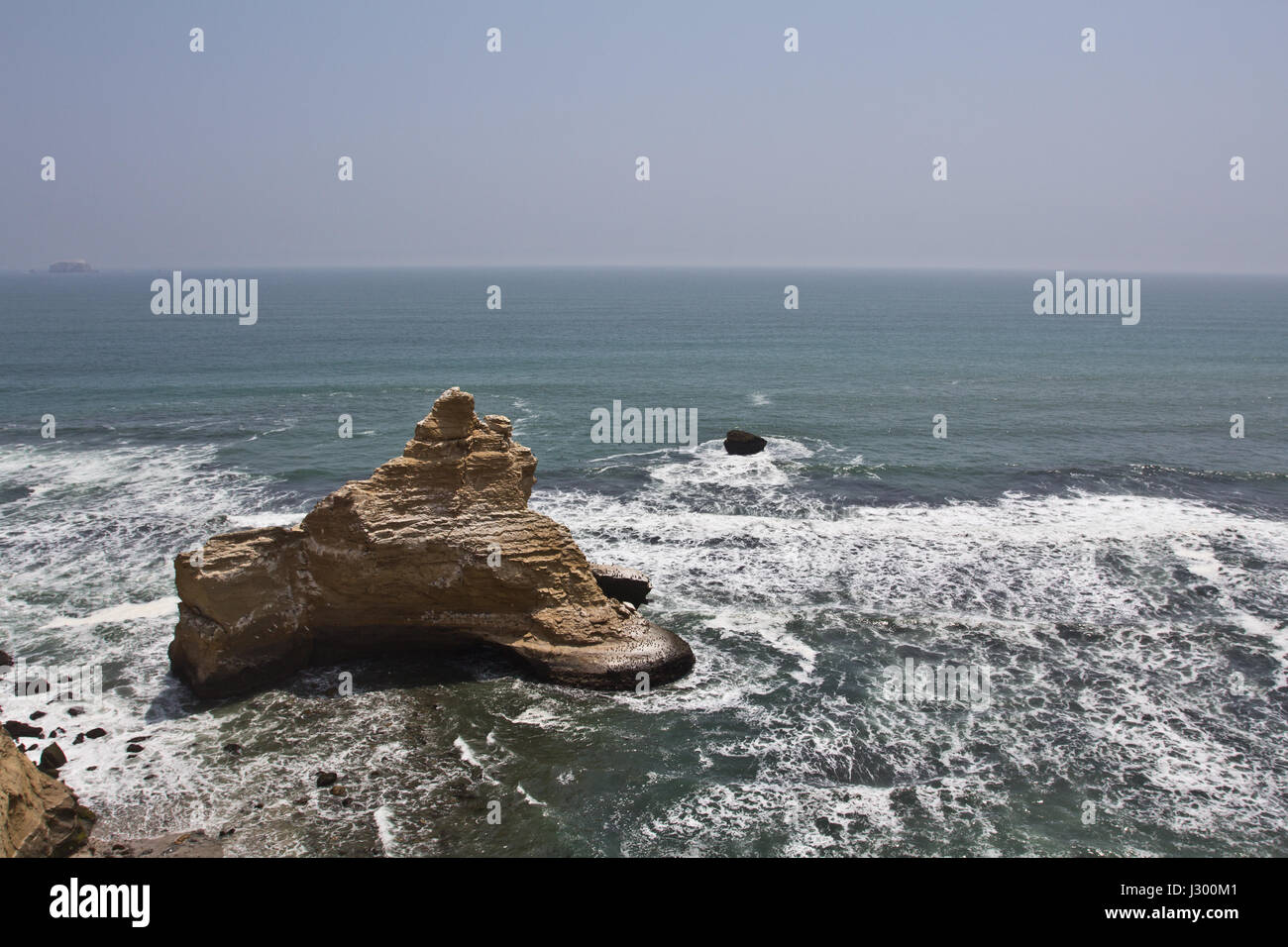 Rocky cliff and ocean with surf. Perfect place to see tropical desert ...