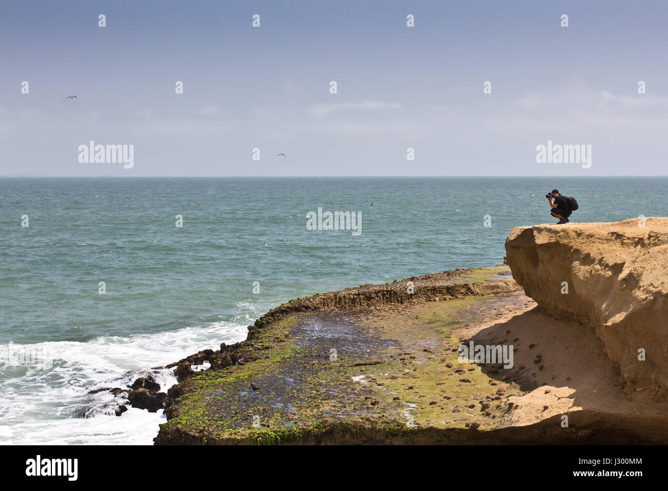 Rocky cliff and ocean with surf. Perfect place to see tropical desert ...