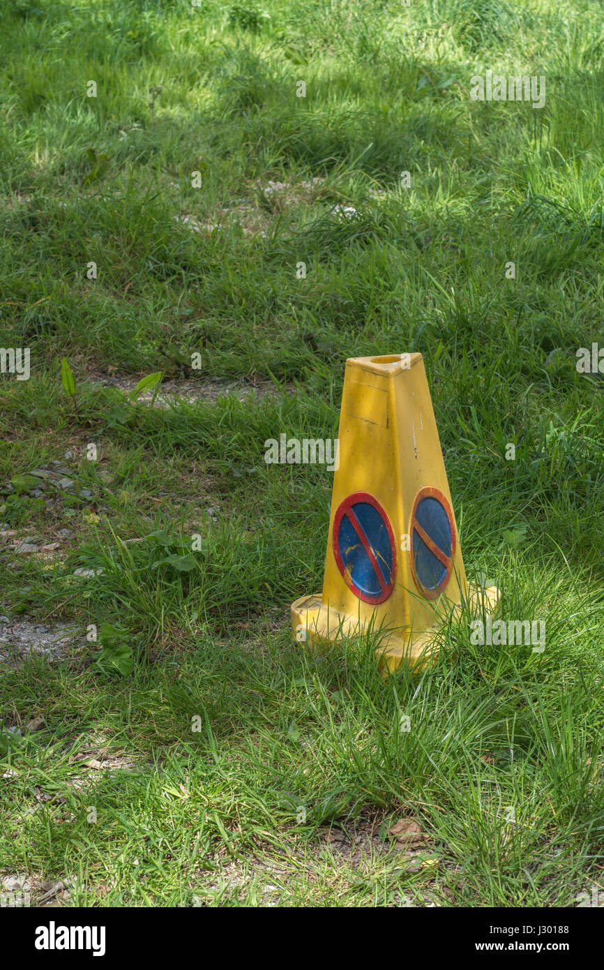 Triangular 'No Waiting' traffic management cone seen on grass verge ...