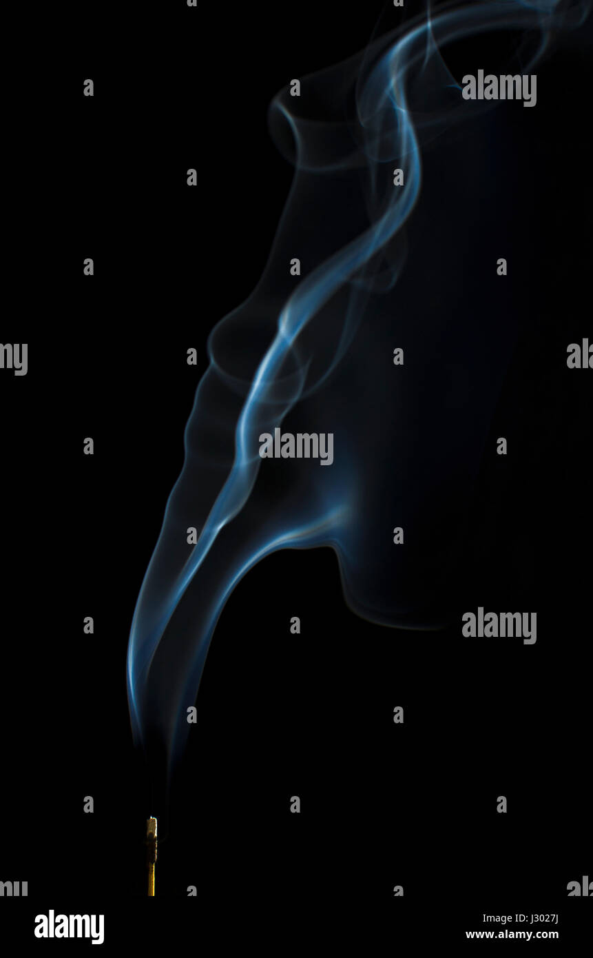 Incense smoke against dark background Stock Photo - Alamy