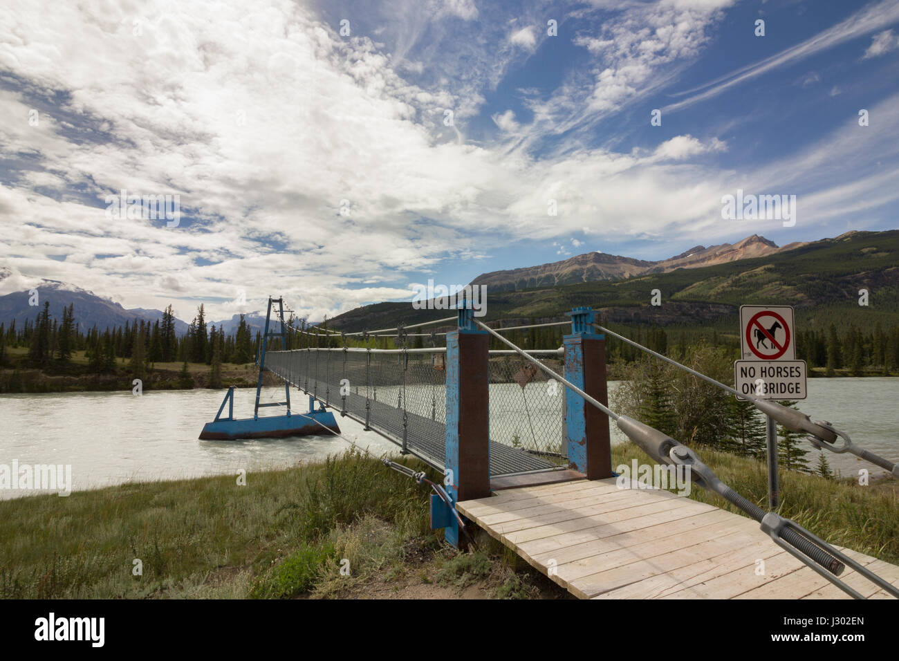 A suspension bridge spanning the North Saskatchewan River in Siffleur ...