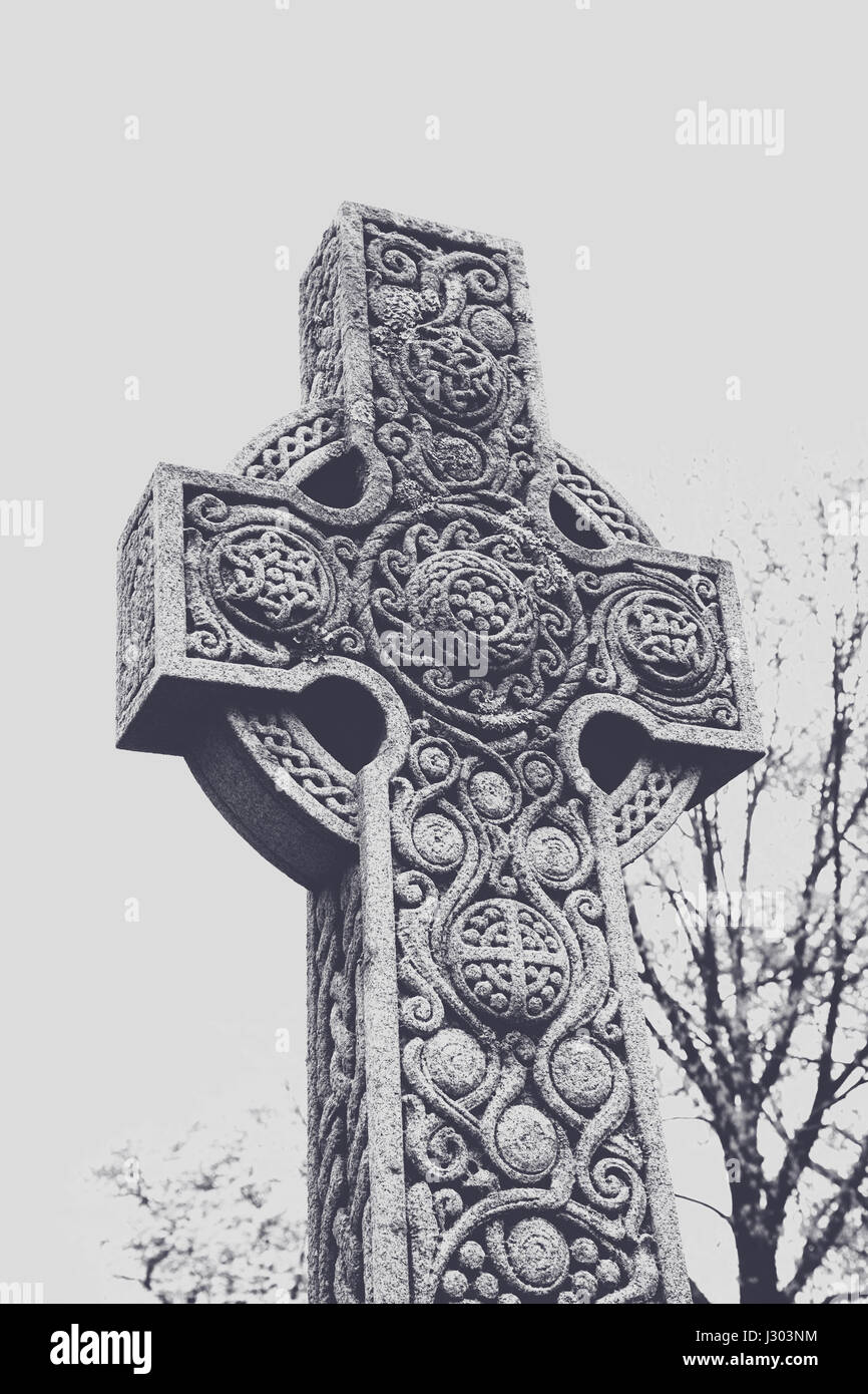 A Celtic cross tombstone with ornate details in an old cemetery Stock ...