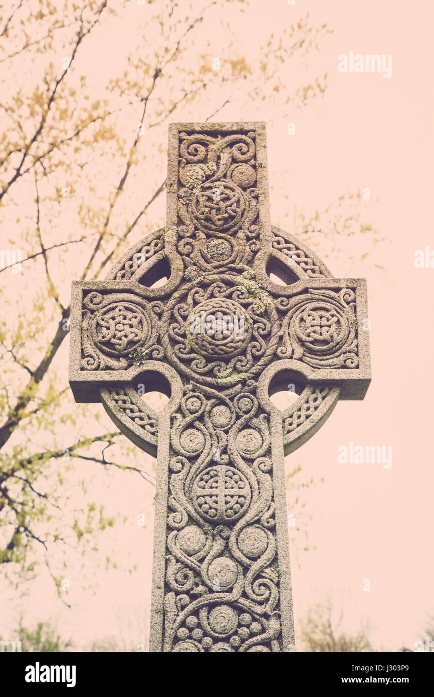 A Celtic cross tombstone with ornate details in an old cemetery Stock ...