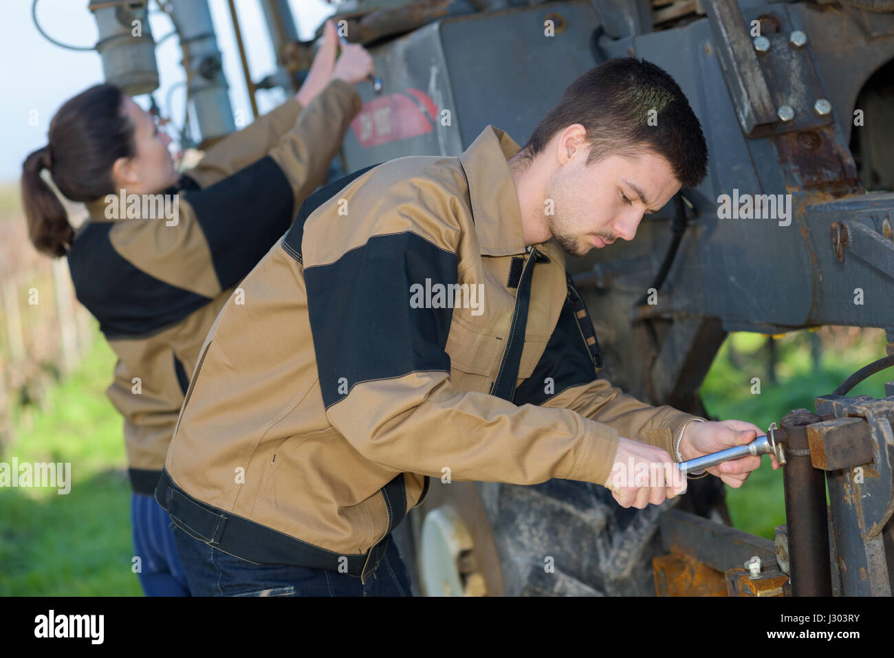 young worker checks the pressure of the engine Stock Photo - Alamy