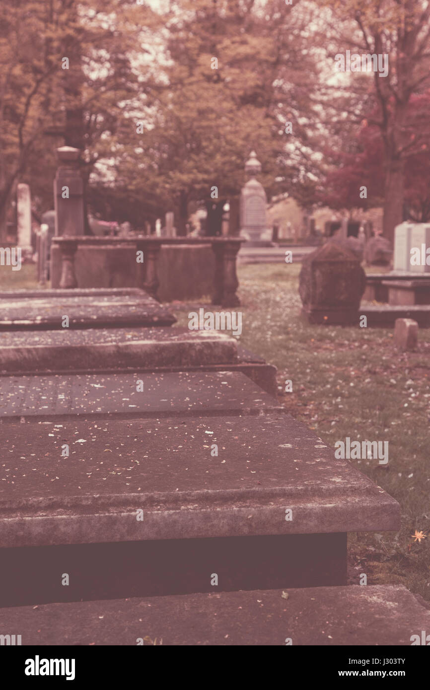 Very old stone crypts are seen in a pre Revolutionary War cemetery ...