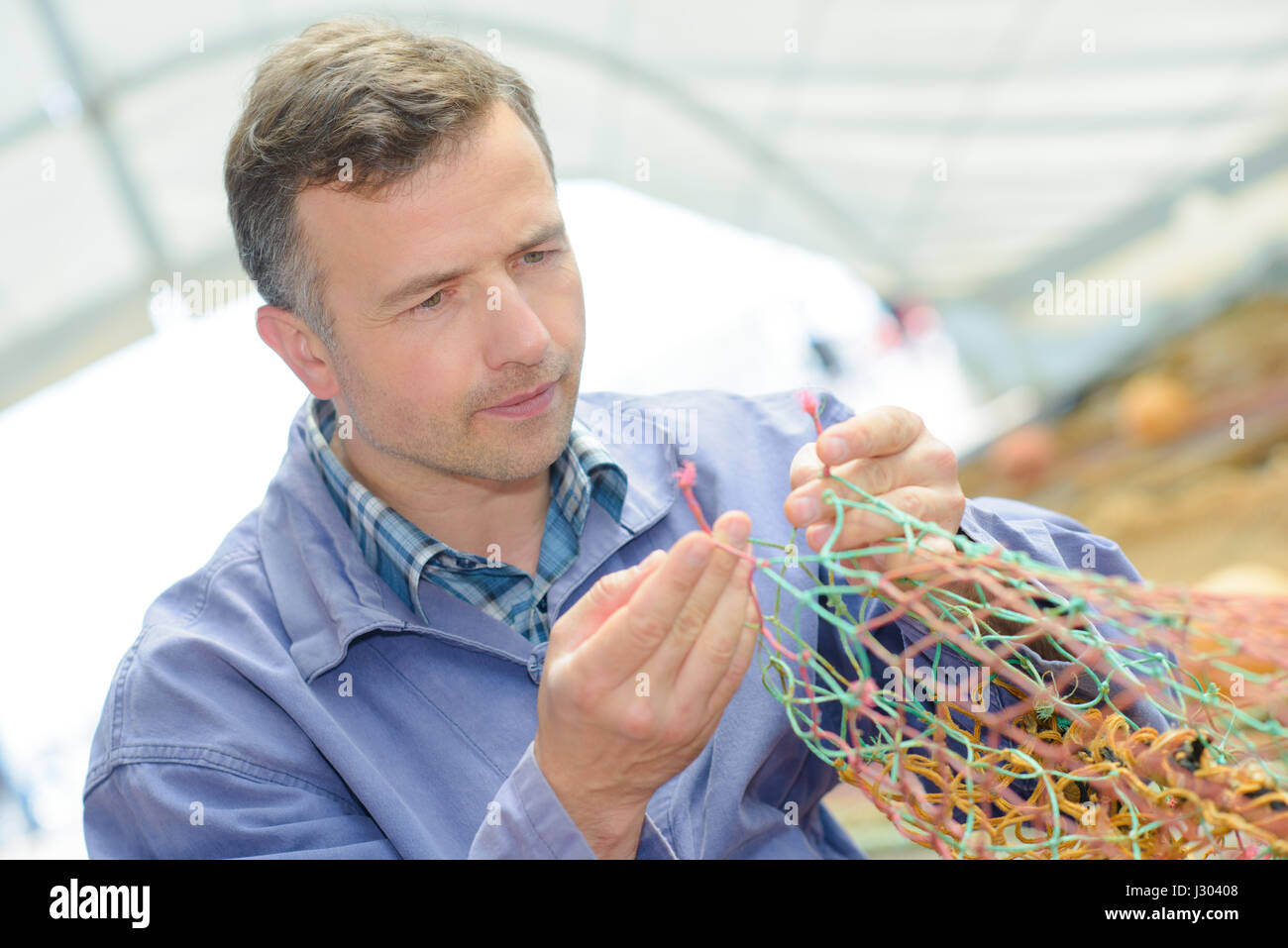 fixing a net Stock Photo - Alamy