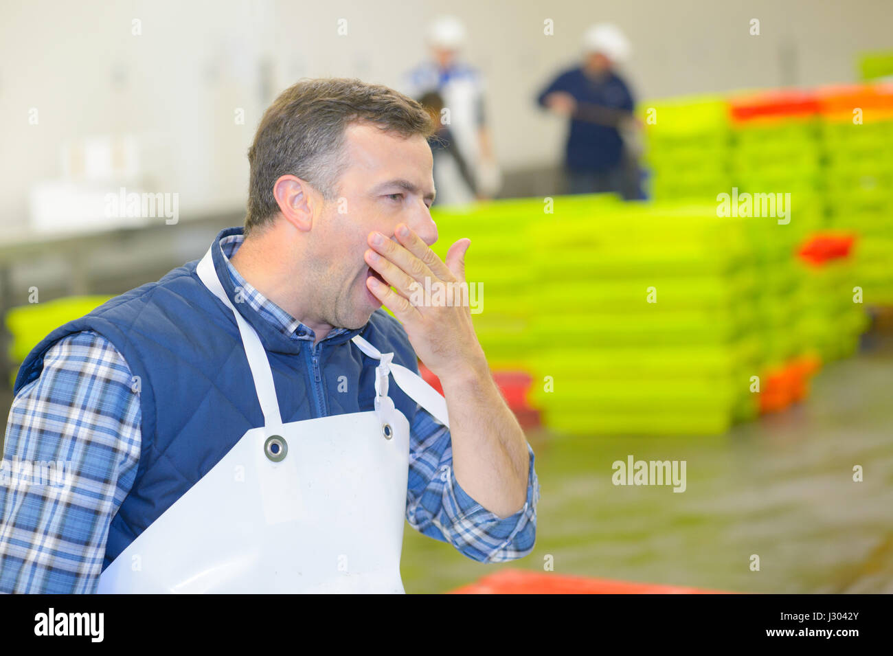 Man at work, yawning Stock Photo - Alamy