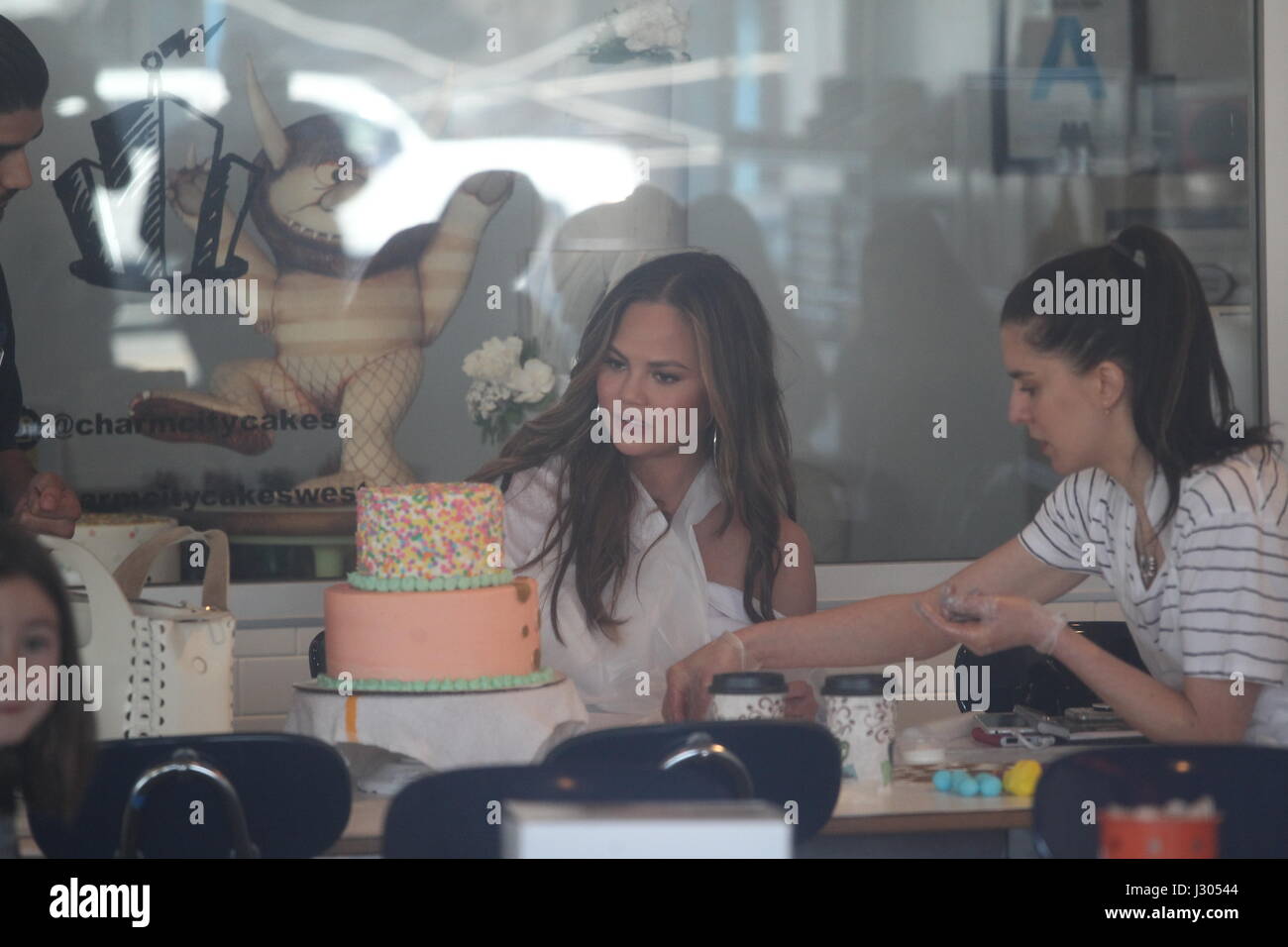 Chrissy Teigen prepares her daughter's first birthday cake Featuring ...