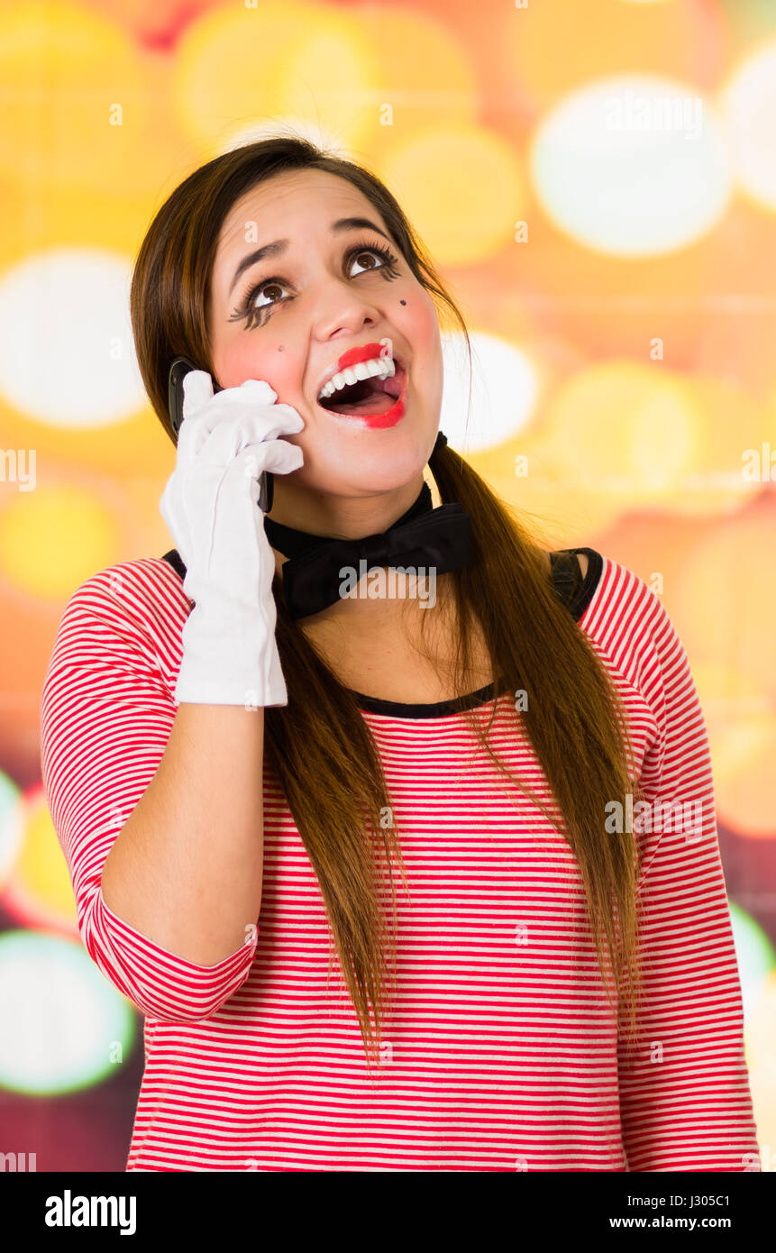 Closeup portrait of cute young girl clown mime using cell phone Stock ...