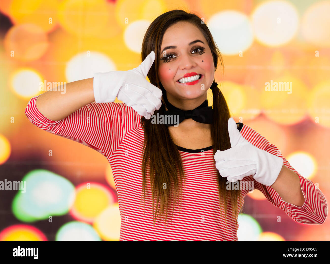 Closeup portrait of cute young girl clown mime holding thumbs up Stock ...