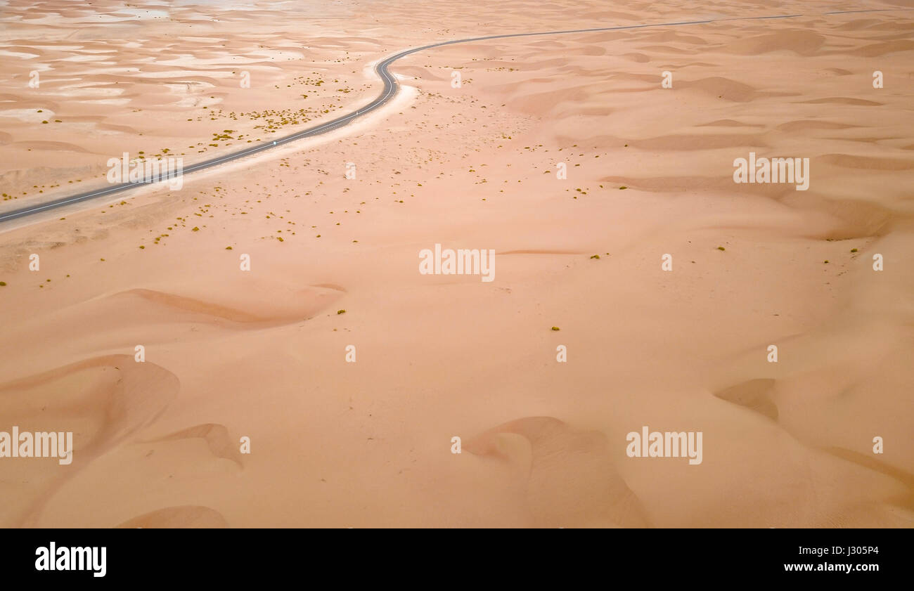 Winding desert road in the middle of dunes in Liwa desert. Liwa, UAE ...