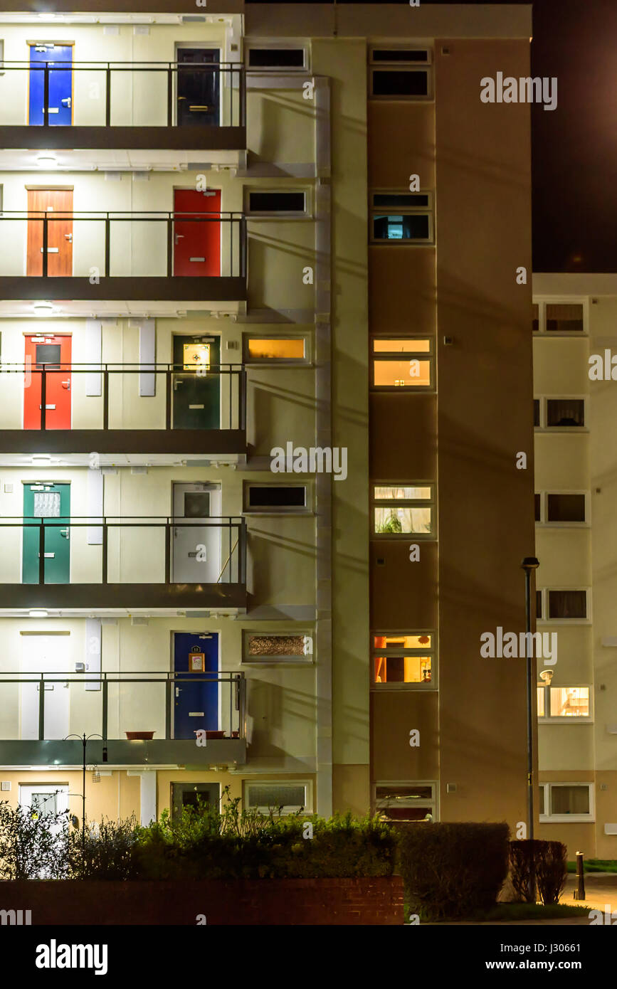 Appartment building with multi color doors at night Stock Photo - Alamy