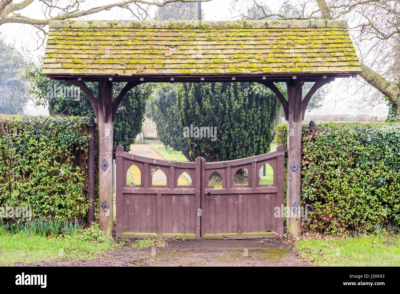 Day view of old English wooden cemetery gates Stock Photo - Alamy