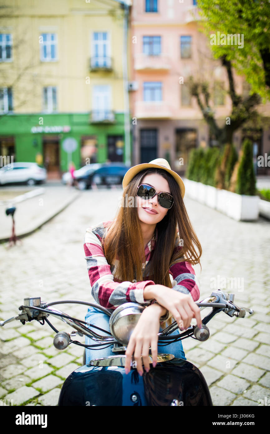 Beauty on scooter. Excited young and beautiful woman riding scooter ...