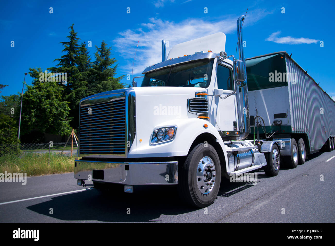 Contemporary modern and comfortable white big rig semi truck with day ...