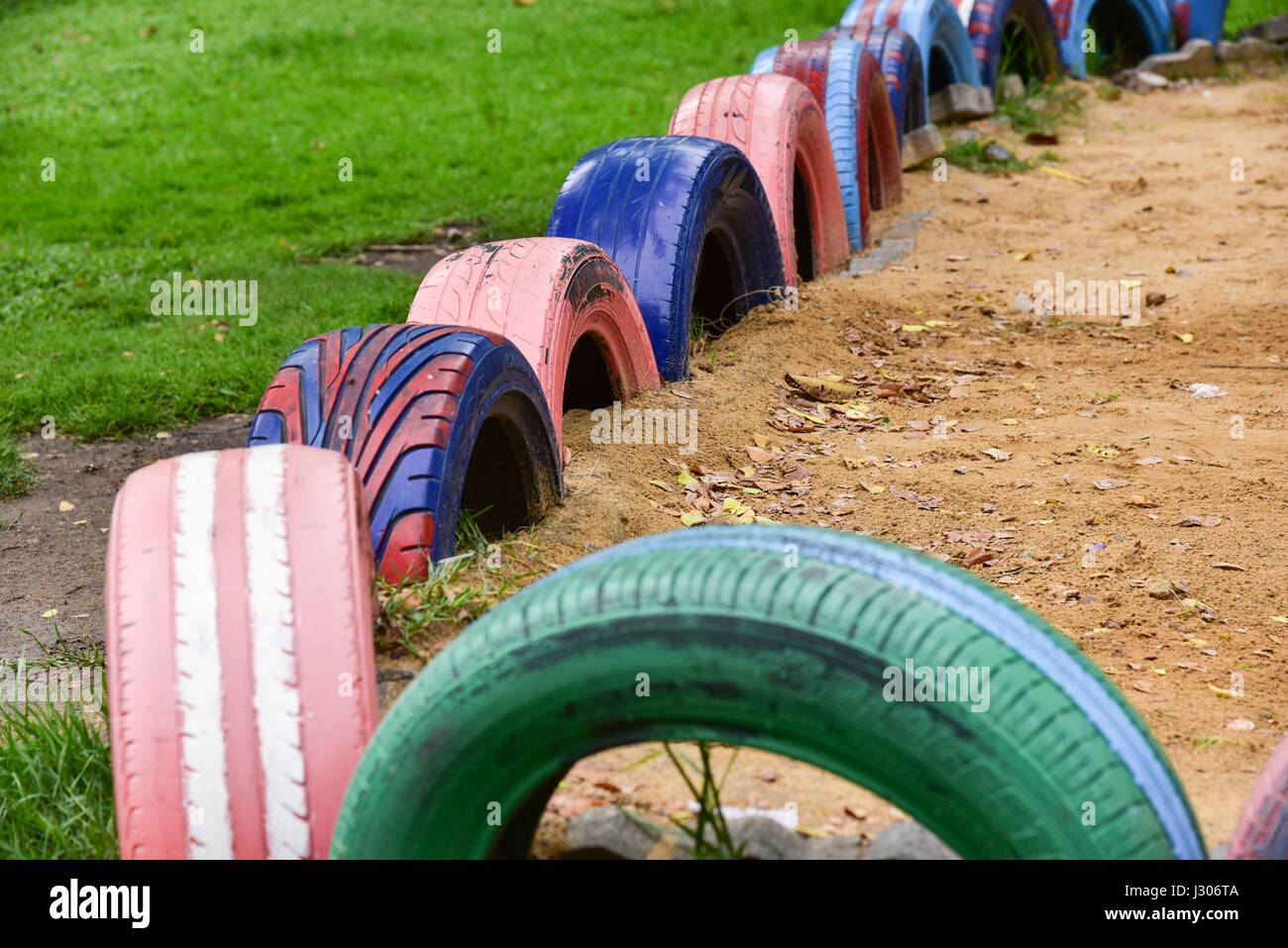 Tires with colorful paint on a playground Stock Photo - Alamy