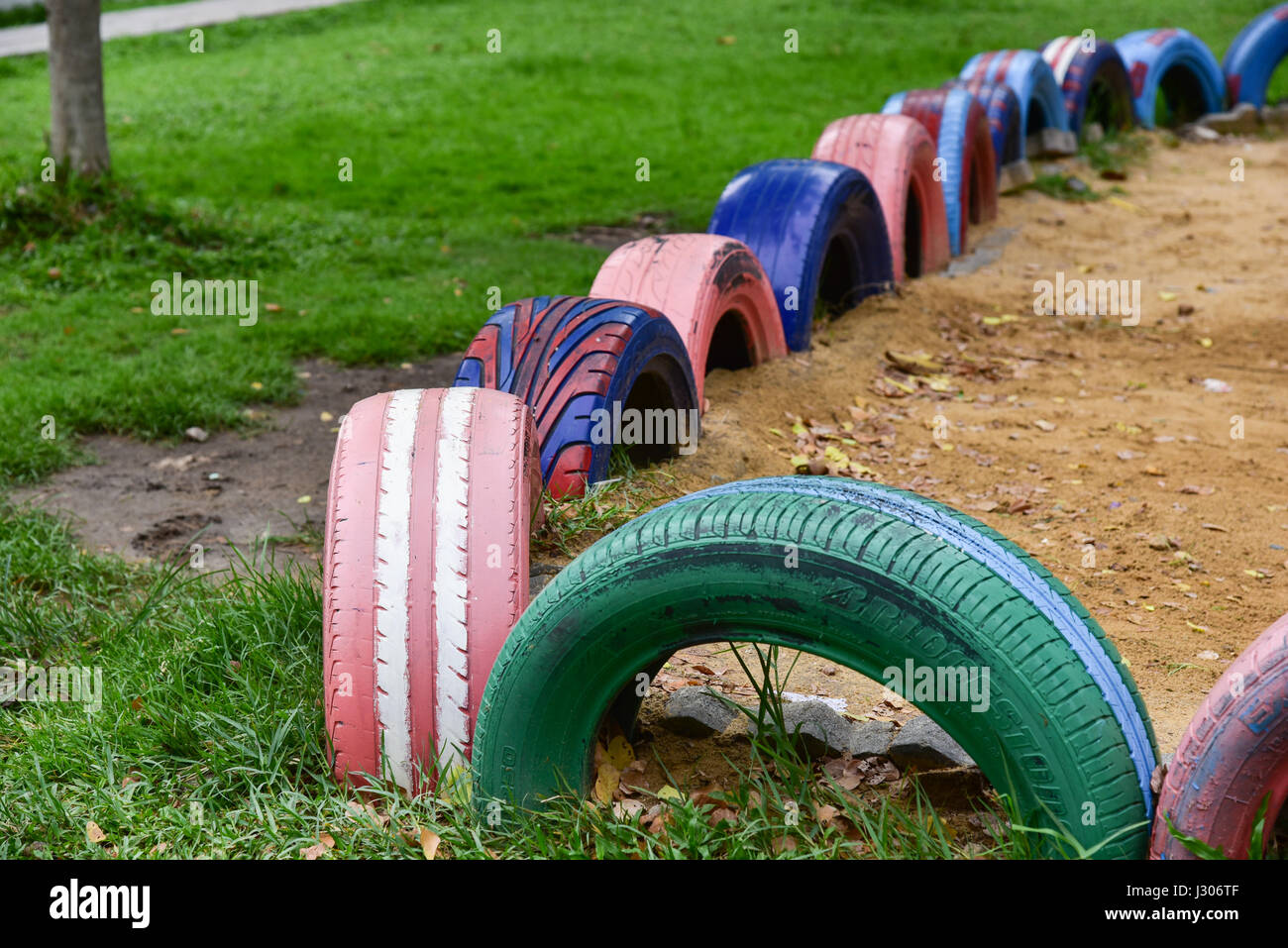 Tires with colorful paint on a playground Stock Photo - Alamy
