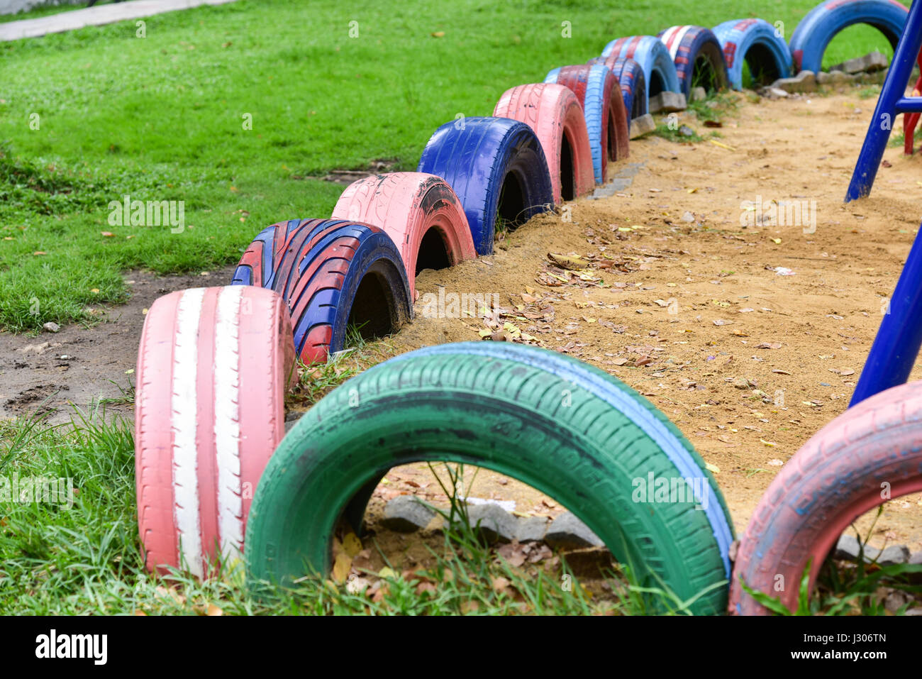 Tires with colorful paint on a playground Stock Photo - Alamy