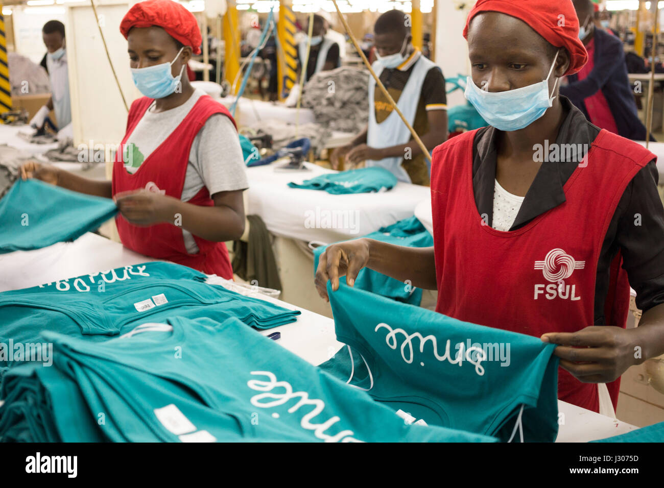 Textile workers producing fabric and clothing at a factory in Kampala ...