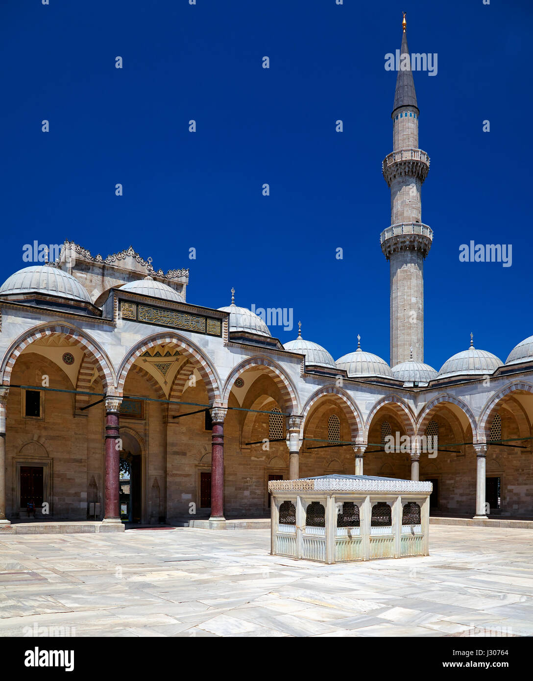 The inner courtyard of Suleymaniye Mosque surrounded by the arched ...