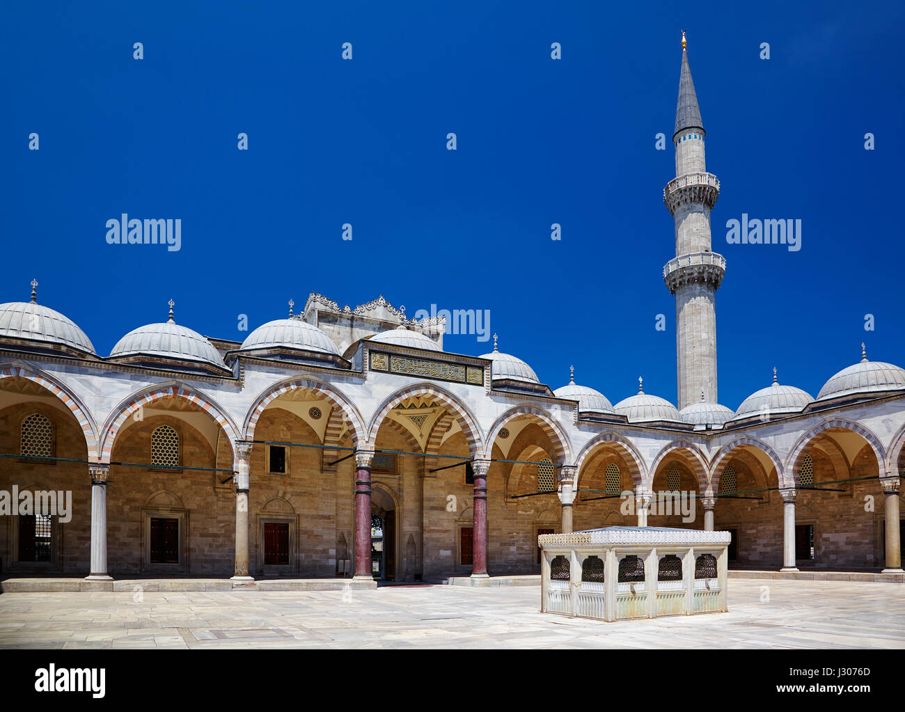The inner courtyard of Suleymaniye Mosque surrounded by the arched ...