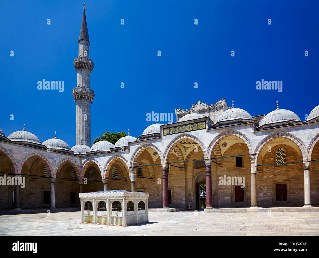 The inner courtyard of Suleymaniye Mosque surrounded by the arched ...