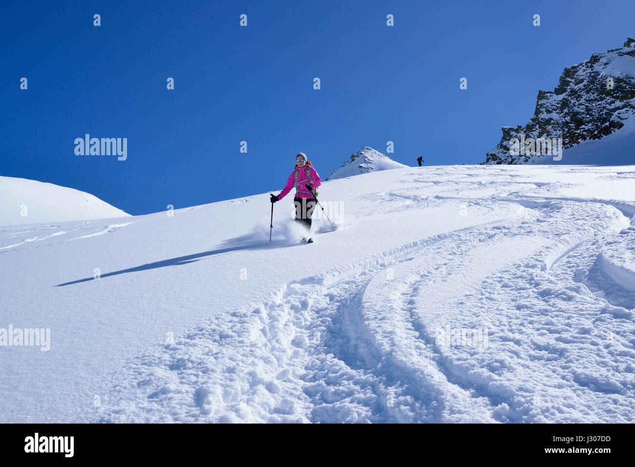 Female back-country skier downhill skiing from Eiskoegele, Obergurgl ...