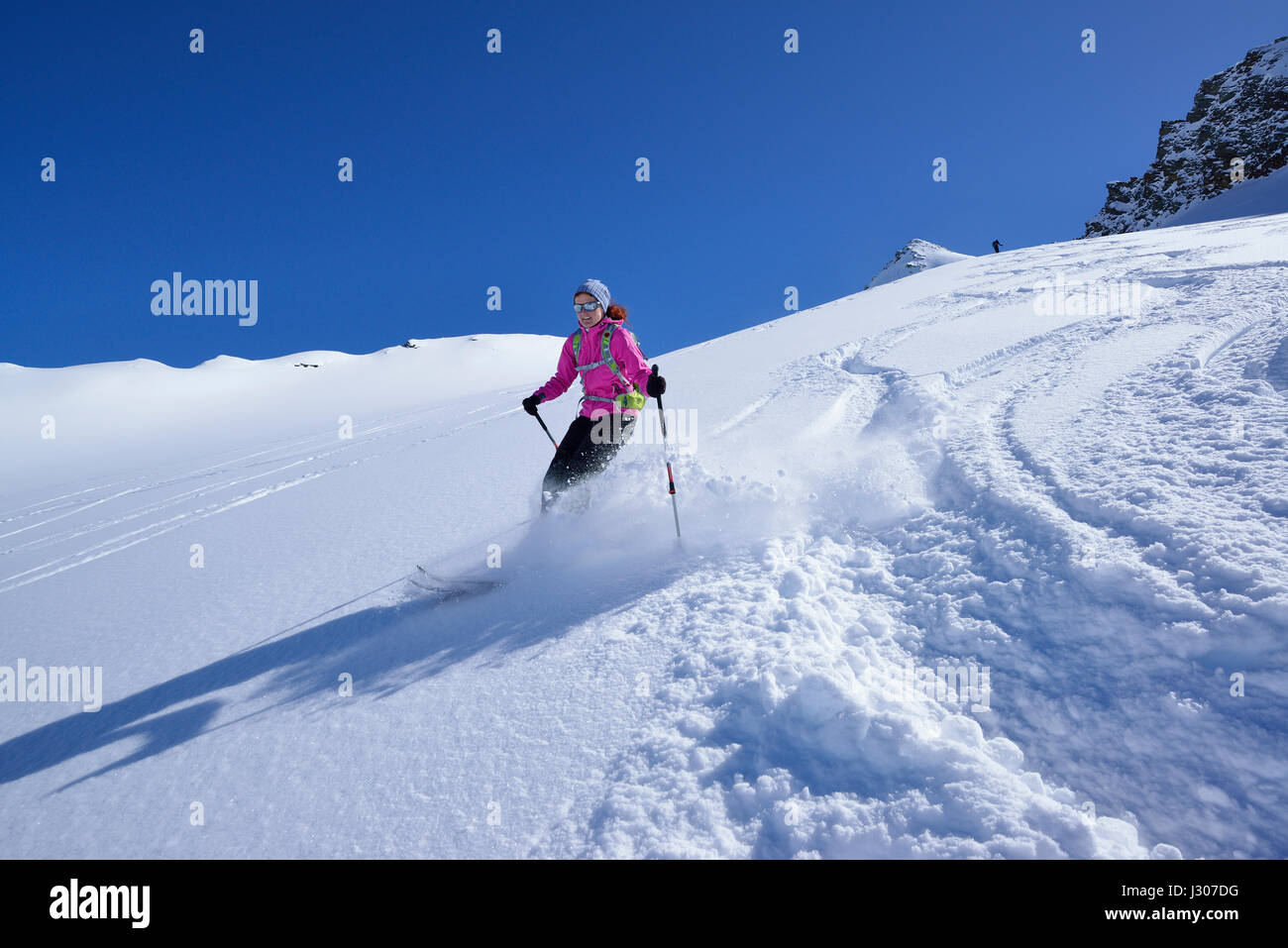 Female back-country skier downhill skiing from Eiskoegele, Obergurgl ...