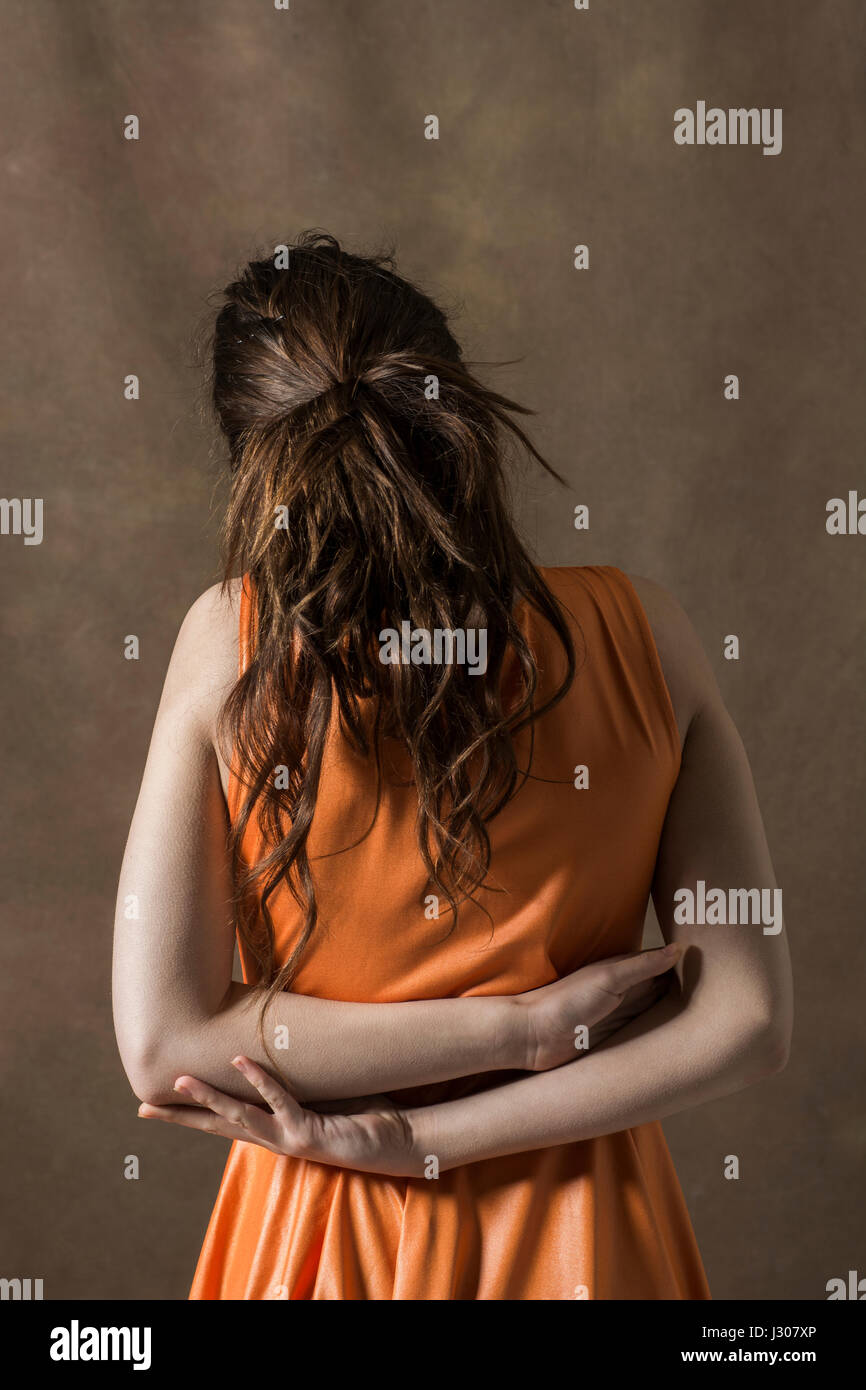 Rear view of a young woman hands behind her back Stock Photo - Alamy