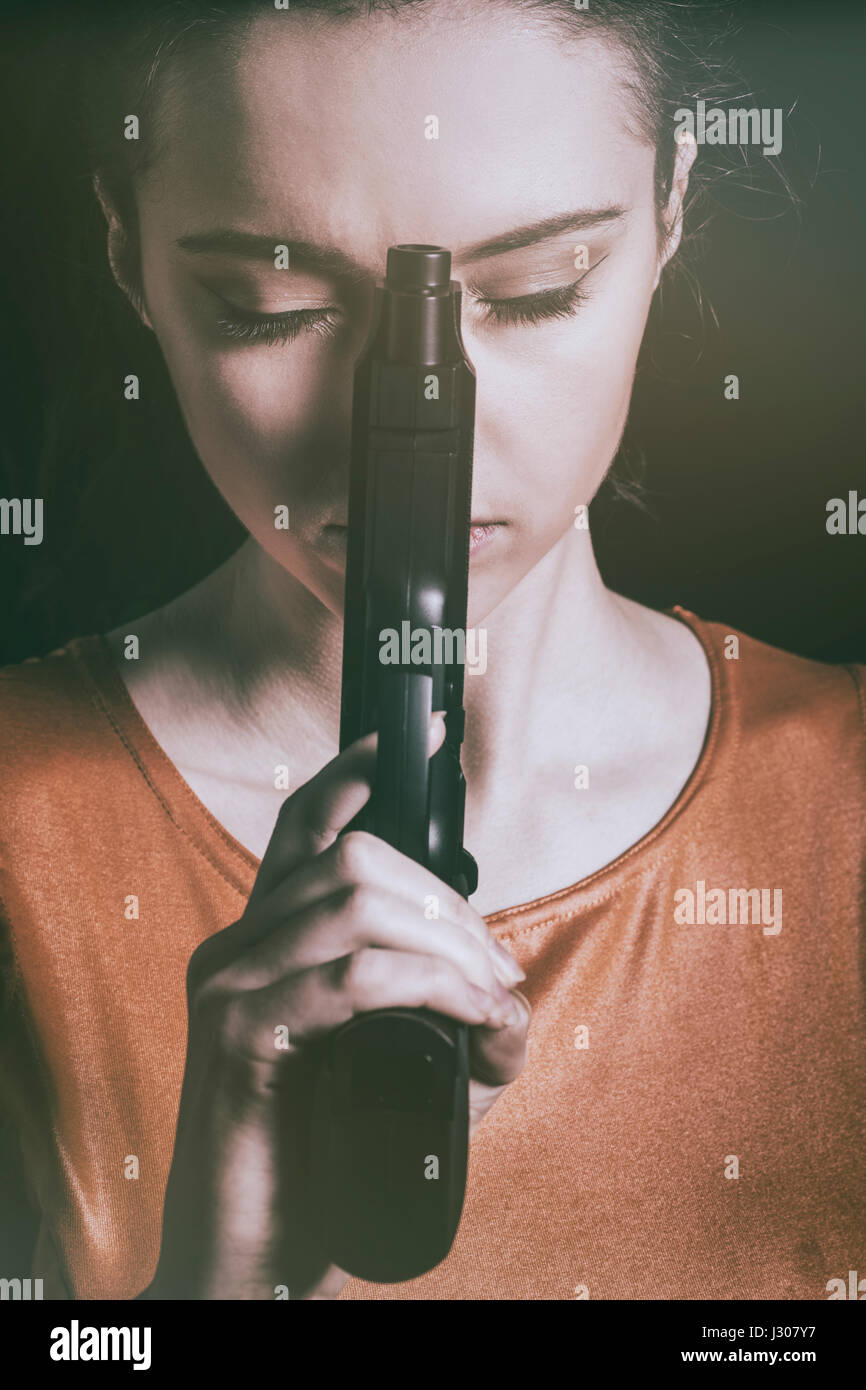Young woman holding a gun Stock Photo - Alamy