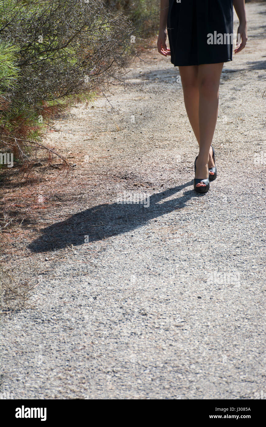 Close up of a young woman's legs walking on a countryside road Stock ...