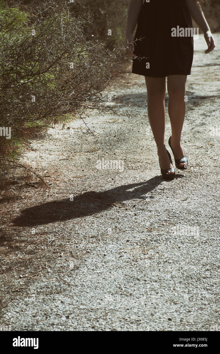 Close up of a young woman's legs walking on a countryside road Stock ...