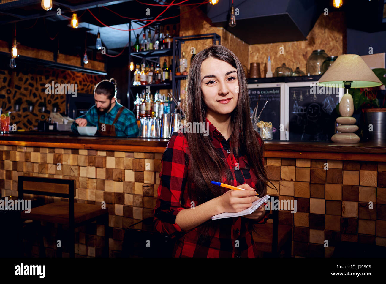 A waiter worker girl takes an order in cafe bar Stock Photo - Alamy