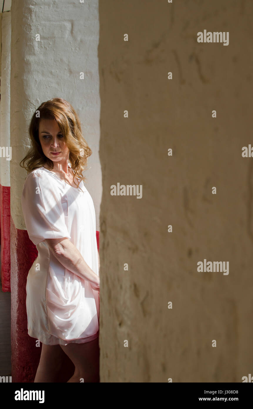 Mature woman looking over shoulder Stock Photo - Alamy