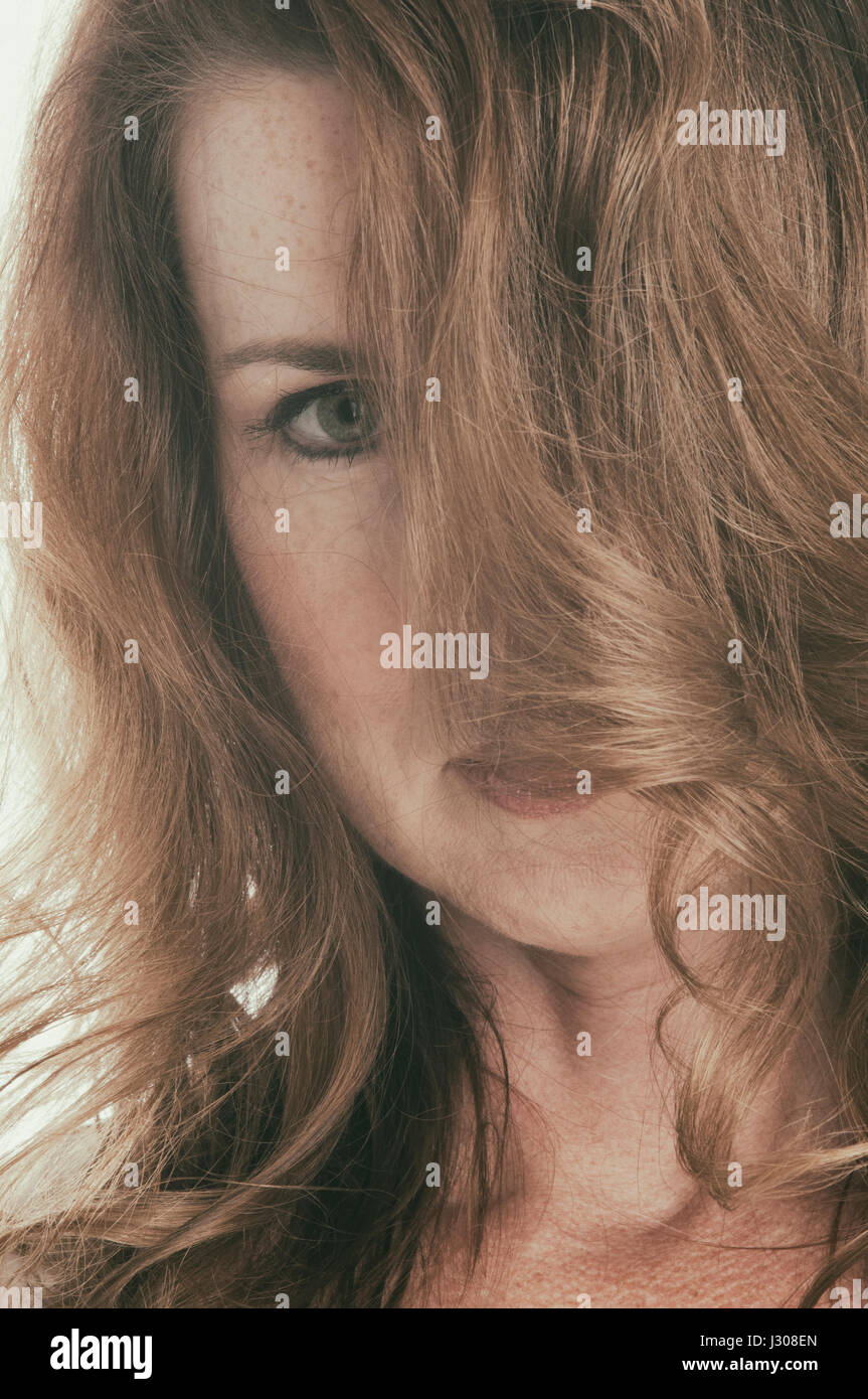 Serious mature woman hair covering face Stock Photo - Alamy