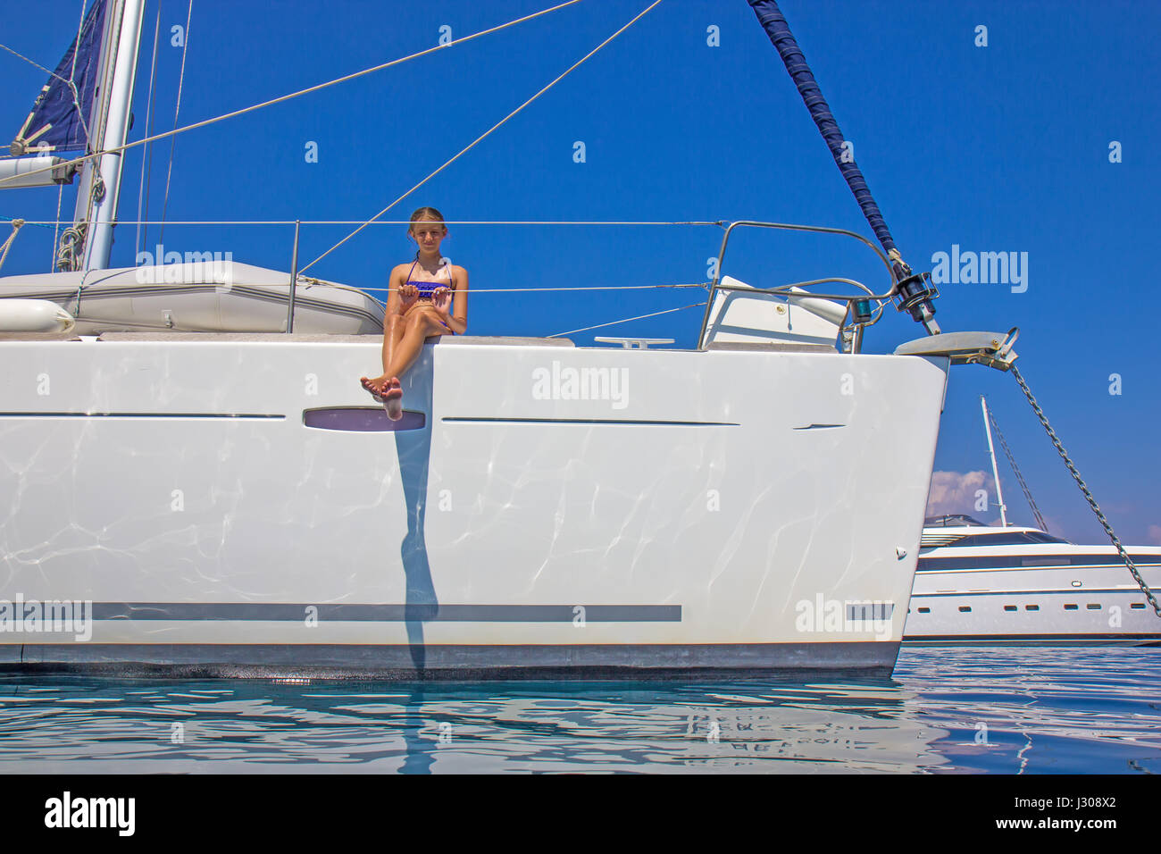 Girl on the sailboat Stock Photo - Alamy
