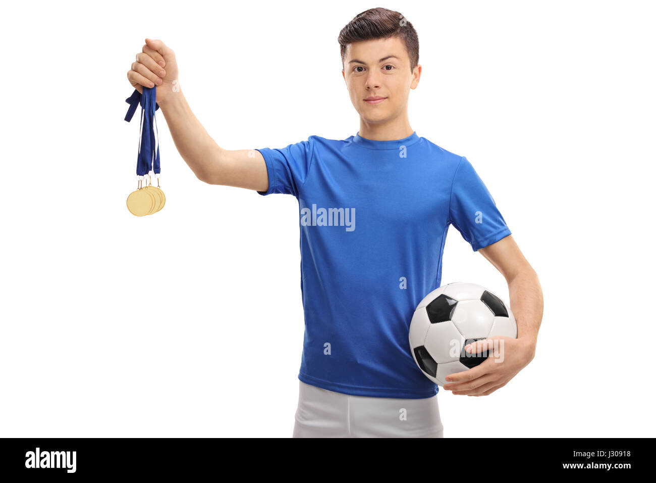 Teenage soccer player with gold medals and a football isolated on white ...