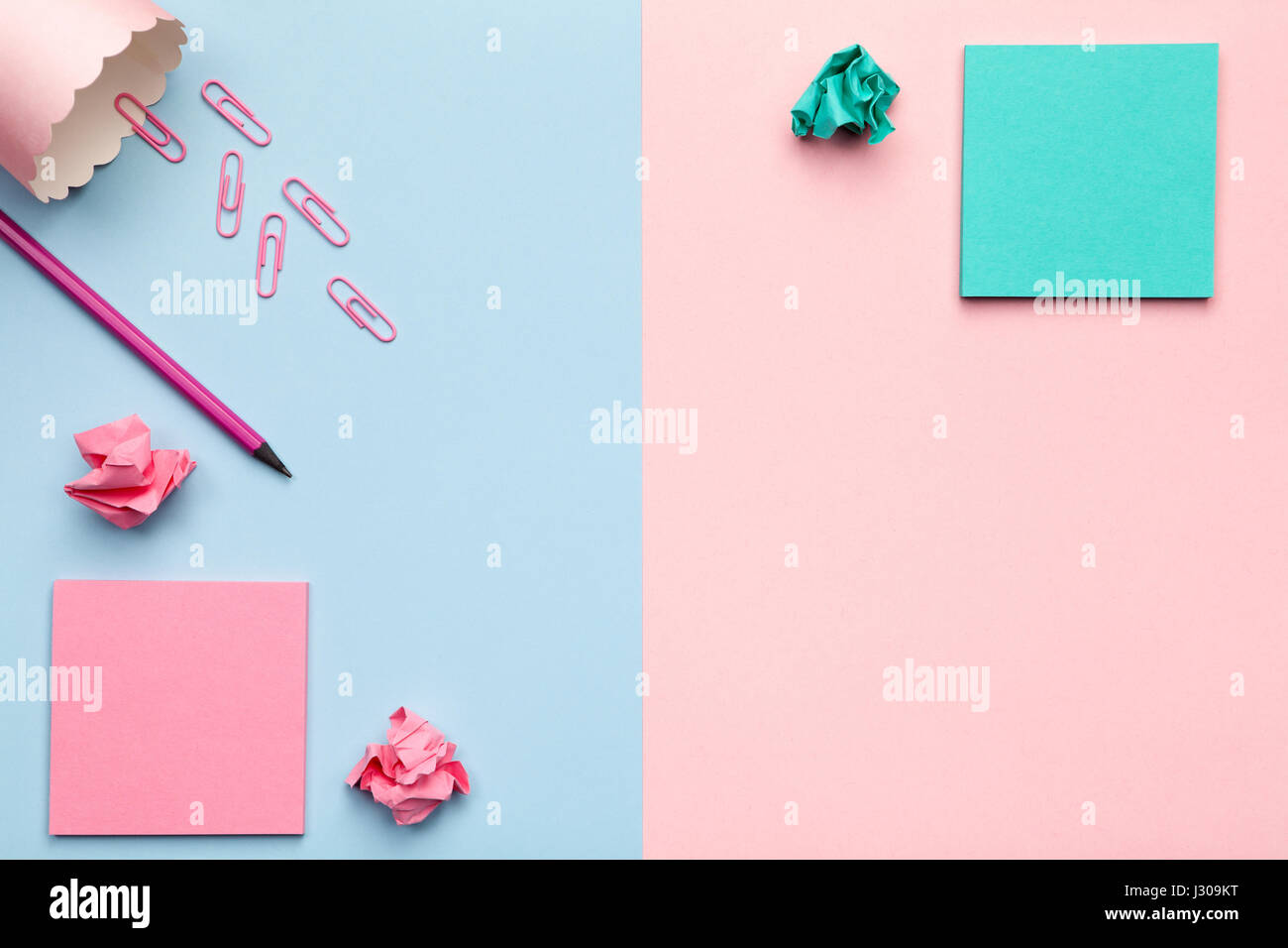 Sticky notes with crumbled paper balls and office accessories on pastel ...