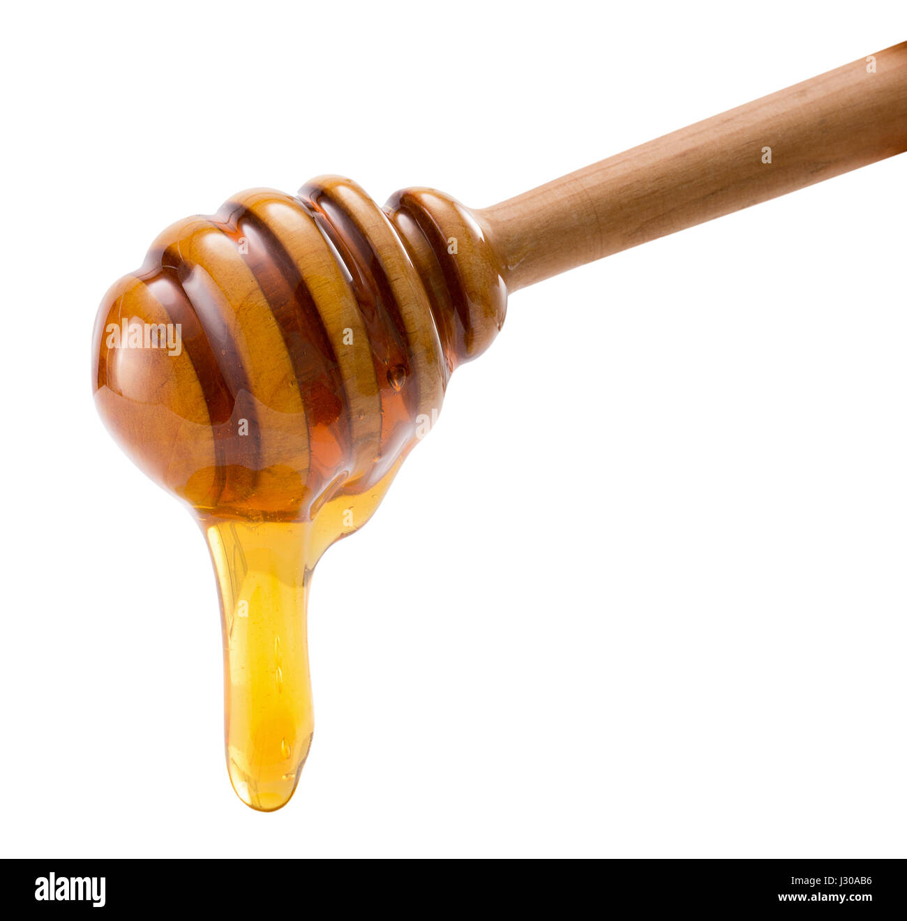 dropping honey isolated on a white background Stock Photo - Alamy