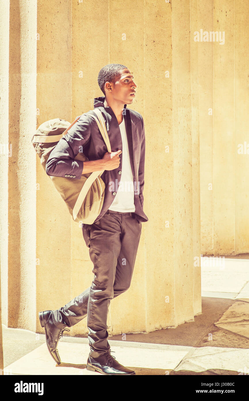 Young African American Man traveling in New York, carrying shoulder bag ...