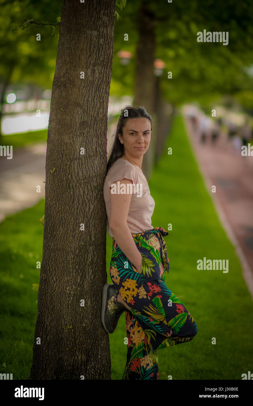 woman lean on tree Stock Photo - Alamy
