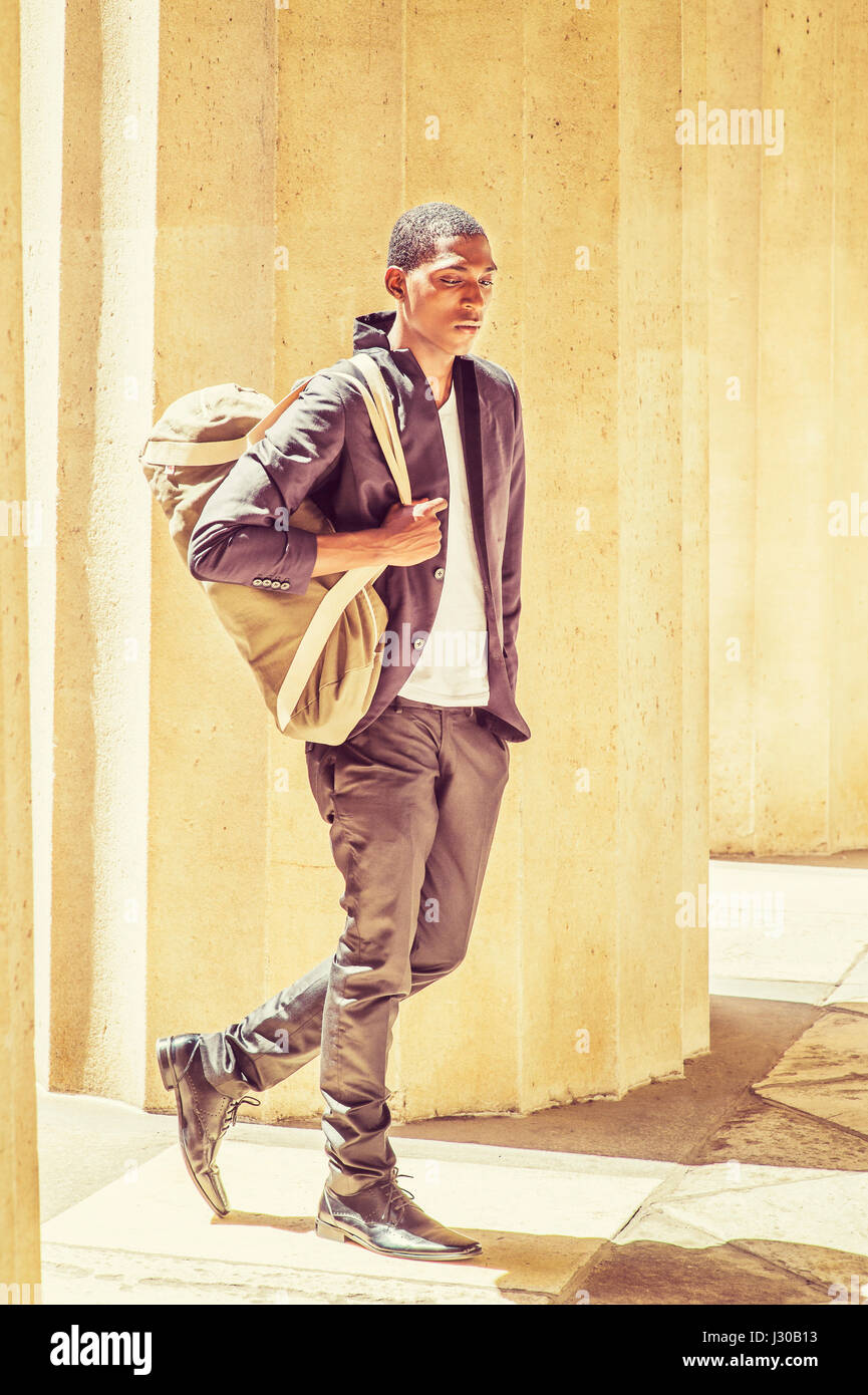 Young African American Man traveling in New York, carrying shoulder bag ...
