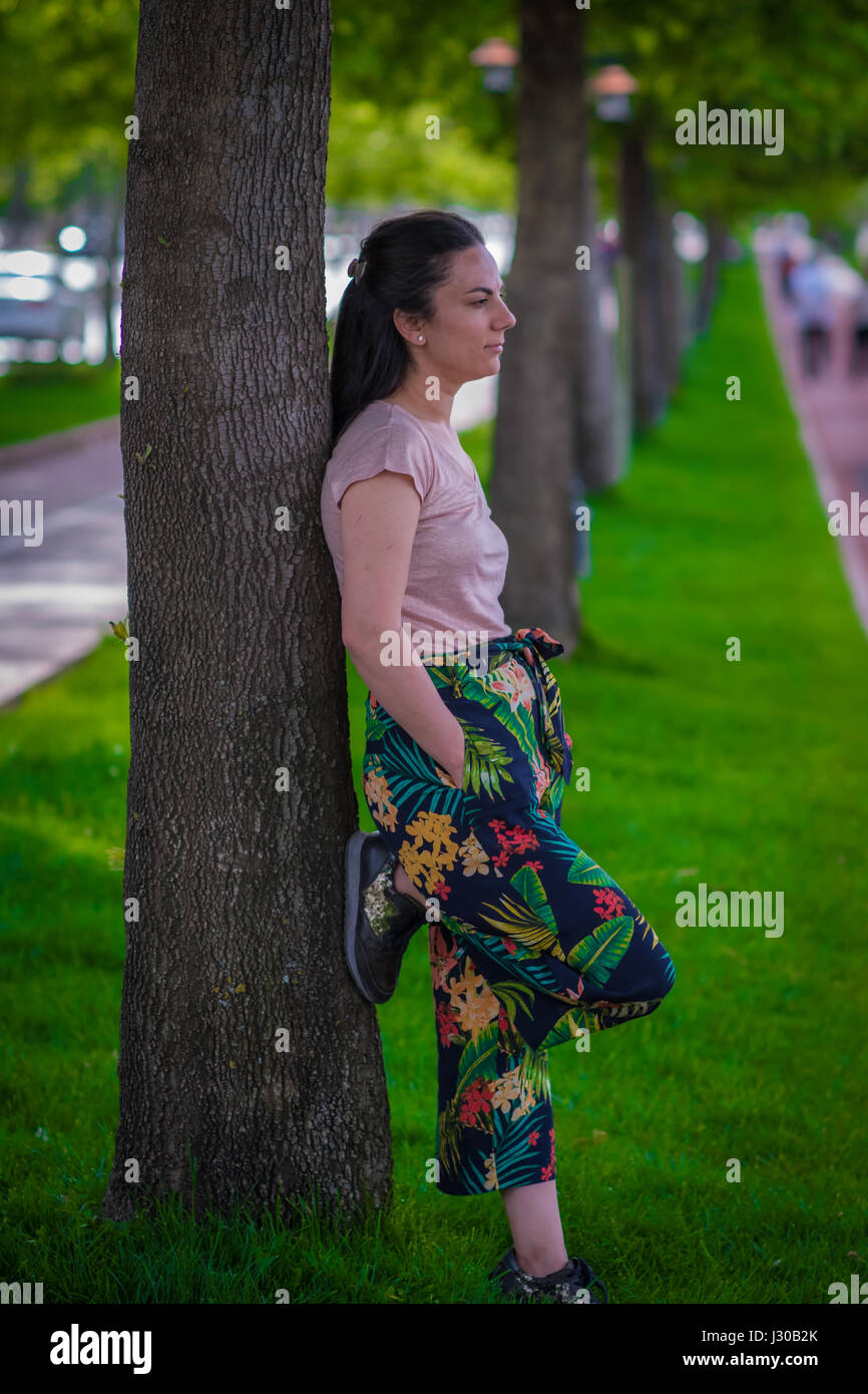 woman lean on tree Stock Photo - Alamy