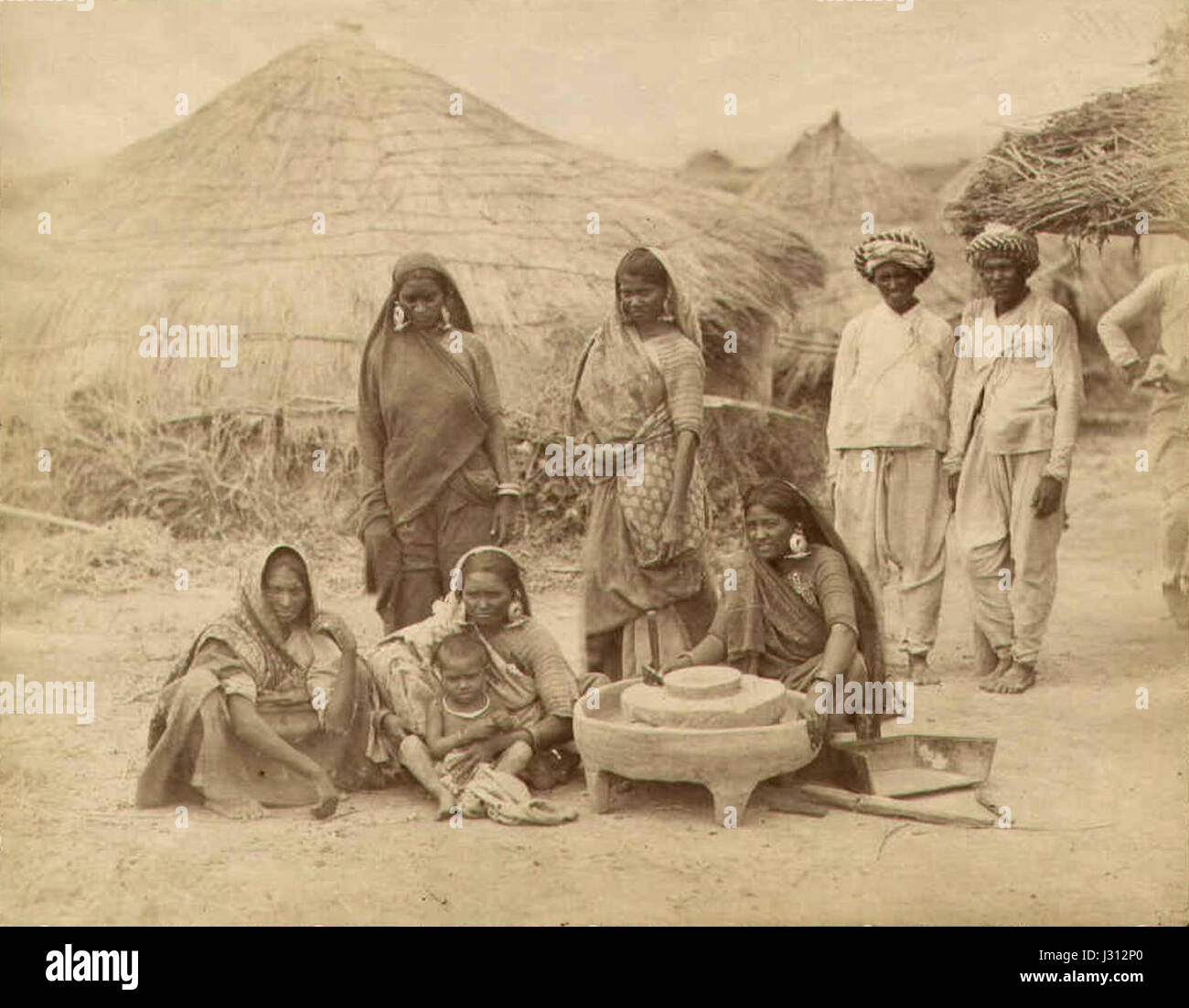 Women grinding corn hi-res stock photography and images - Alamy