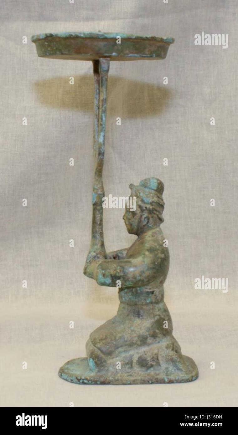 An archaic bronze candle holder, dating from the Han to the Warring ...