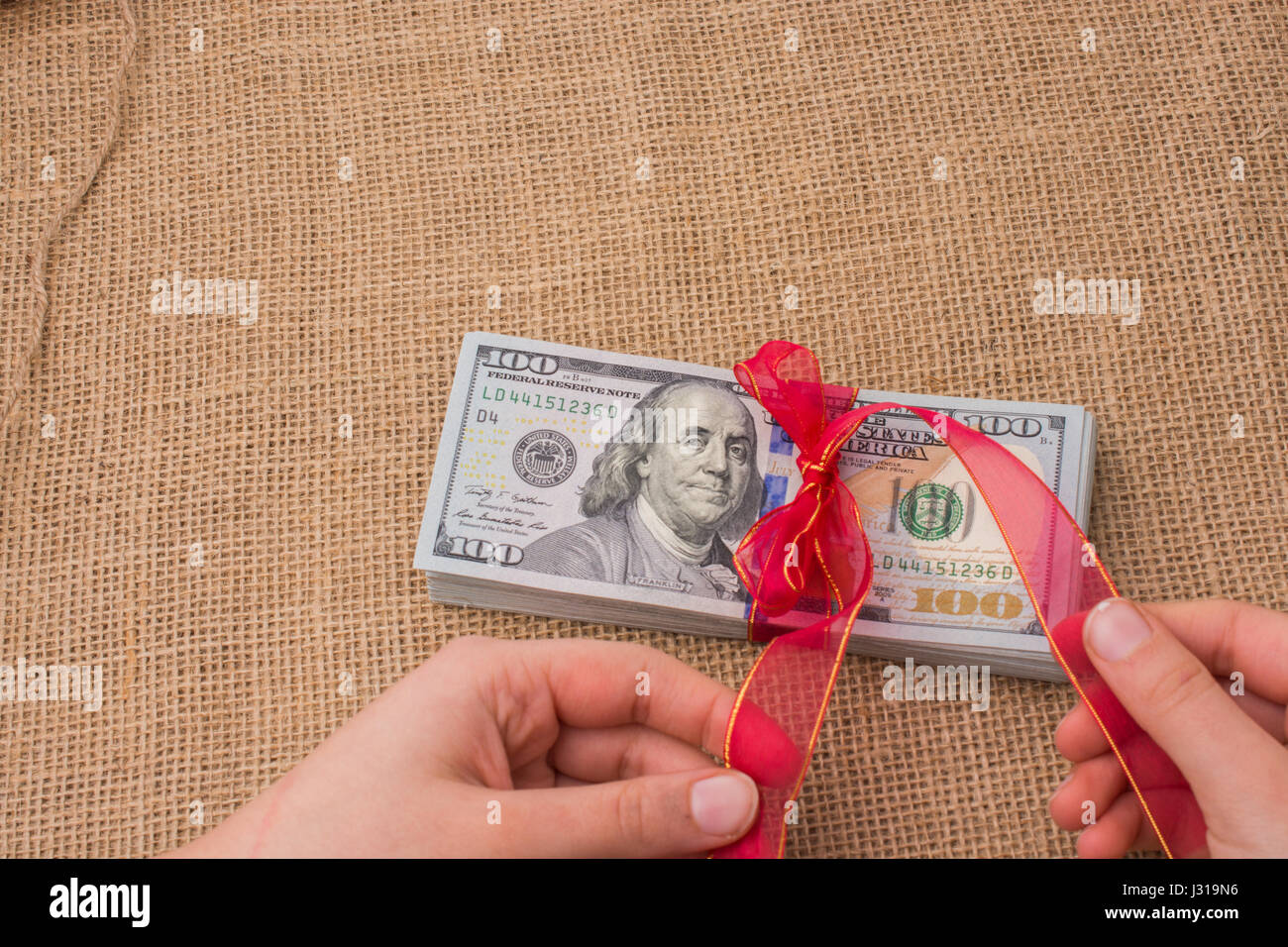 Banknote bundle of US dollar tied with colorful a ribbon Stock Photo ...