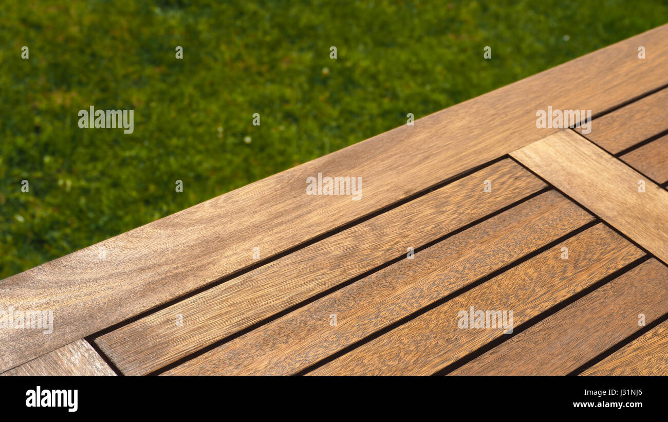 Empty wooden garden table on blurred green grass using as background ...