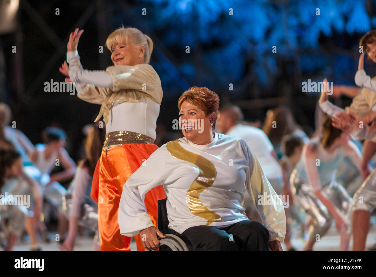 Disabled dancers in wheelchairs dance with other dancers during the ...